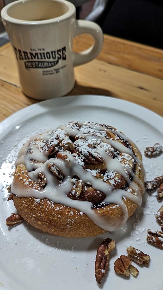 This isn't just a cinnamon roll—it's a spiral-bound love letter to your taste buds, drizzled with icing and sprinkled with pecan confetti.