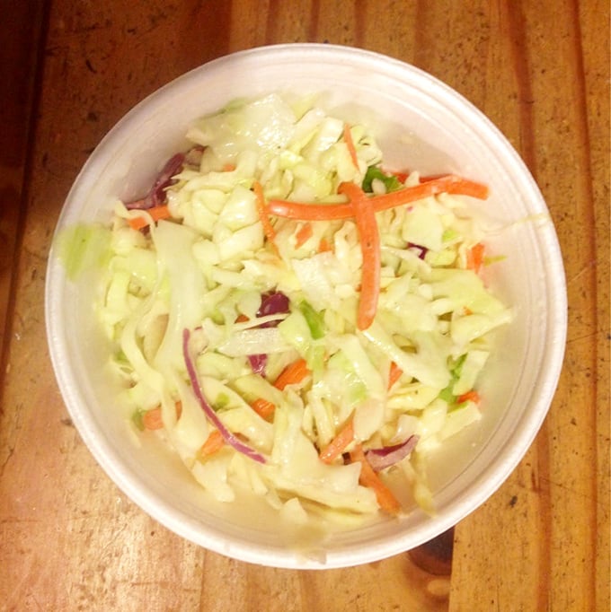 Cole slaw that knows its purpose in life: to bring crisp, tangy relief between bites of rich, smoky meat – the unsung hero of barbecue balance.