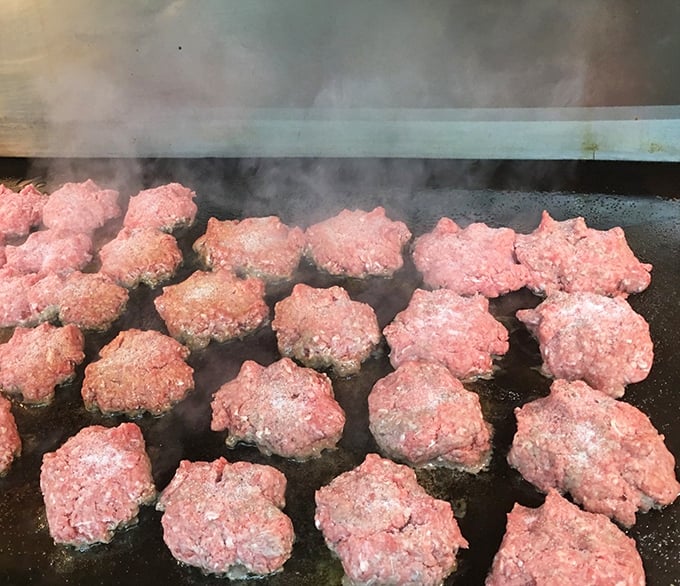 The sizzle of fresh patties hitting the griddle—a sound more musically satisfying than any symphony. This is where burger magic begins.