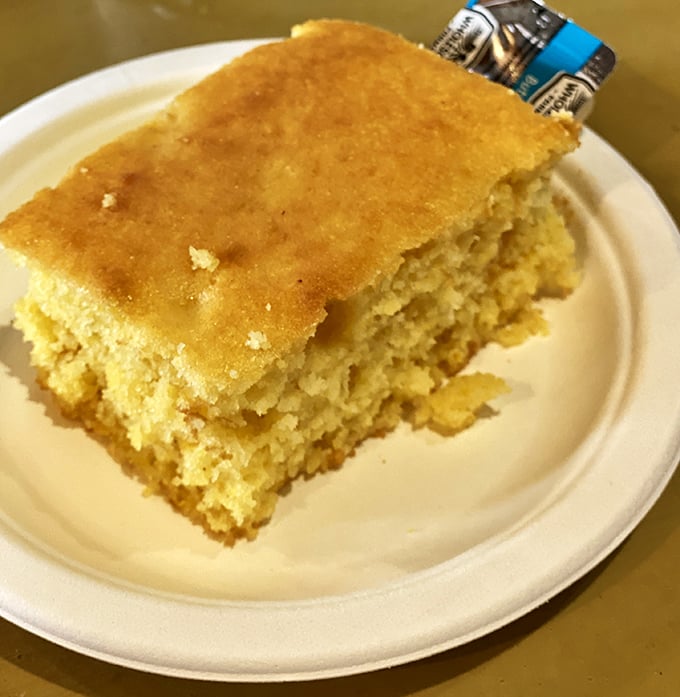 Cornbread so golden it could be currency in a better world. Not too sweet, not too crumbly—the Goldilocks of barbecue companions.