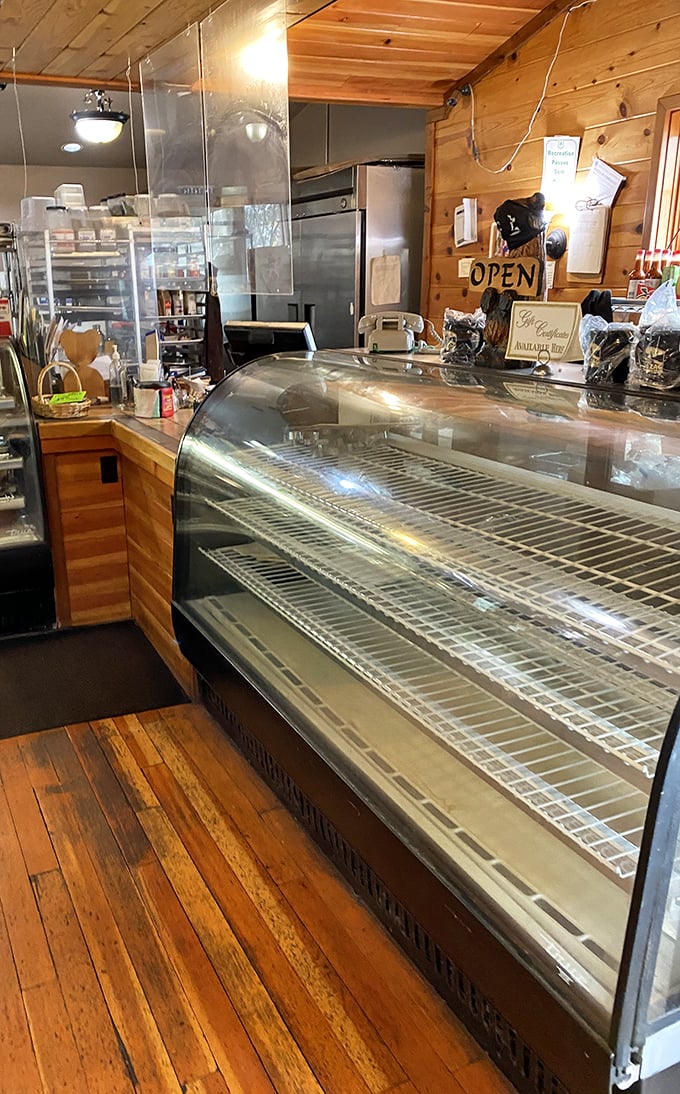 Behind the counter, where culinary magic happens – empty display cases just mean everything's fresh and probably already on someone's happy plate.