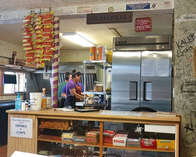 The counter at Herd's isn't just where orders happen—it's command central for burger operations, with chips hanging like stalactites of salty goodness.