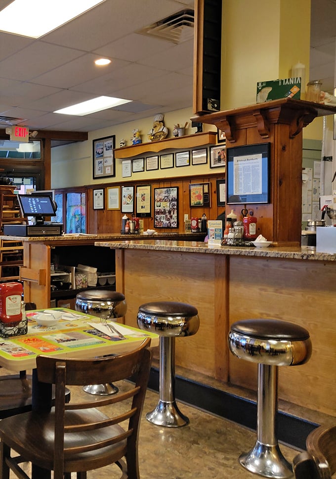 Classic counter seating where breakfast magic happens before your eyes – the best seats in the house for serious eaters.