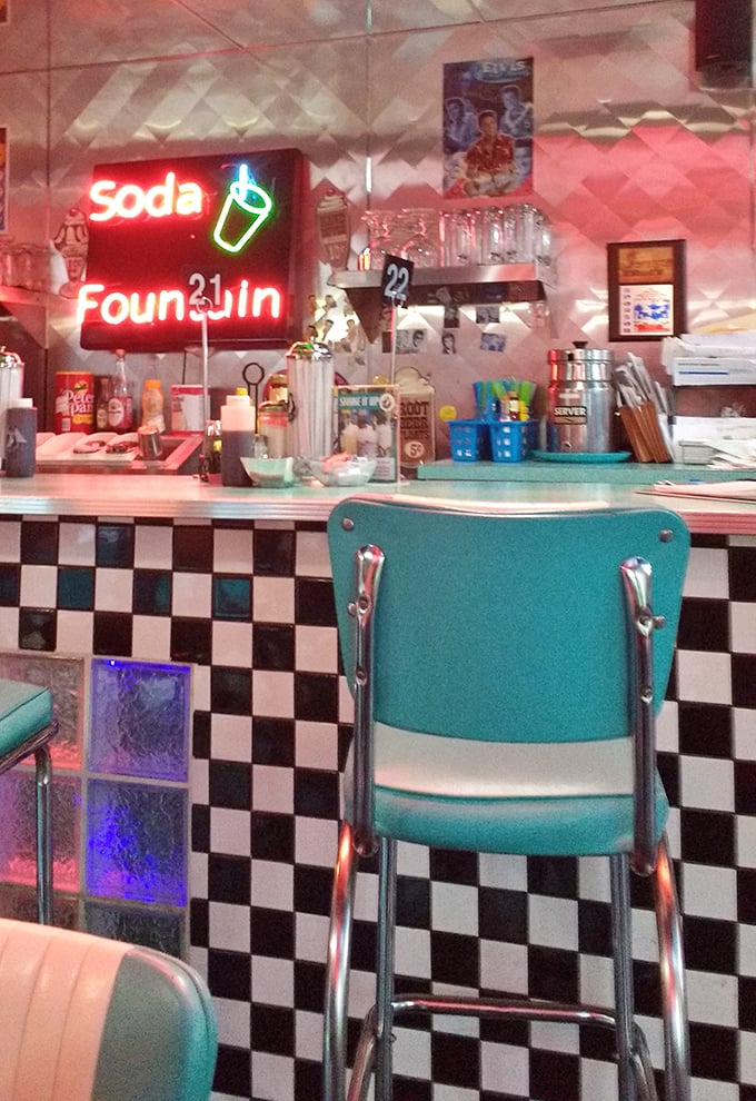 The soda fountain counter, where turquoise dreams and checkered patterns collide, beckons you to slide onto a stool and order "the usual."