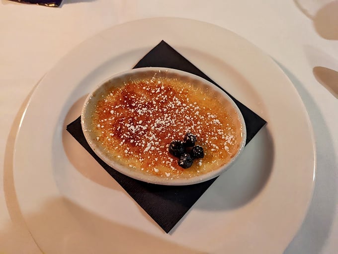 A crème brûlée with a crackling sugar top that shatters with satisfying drama, revealing the silky custard treasure beneath.