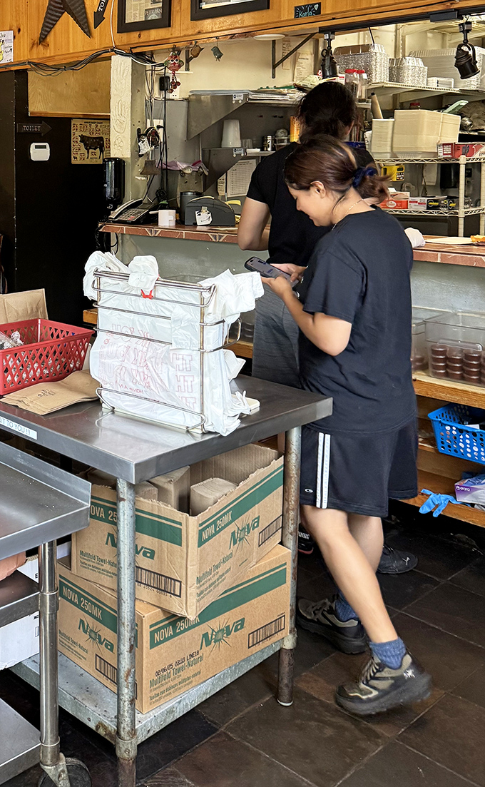 The kitchen crew in their element – where barbecue magic happens with military precision and artistic flair.