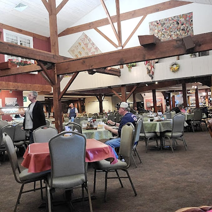 The spacious dining room with its timber-frame construction creates an atmosphere where strangers become friends, united by the universal language of good food.