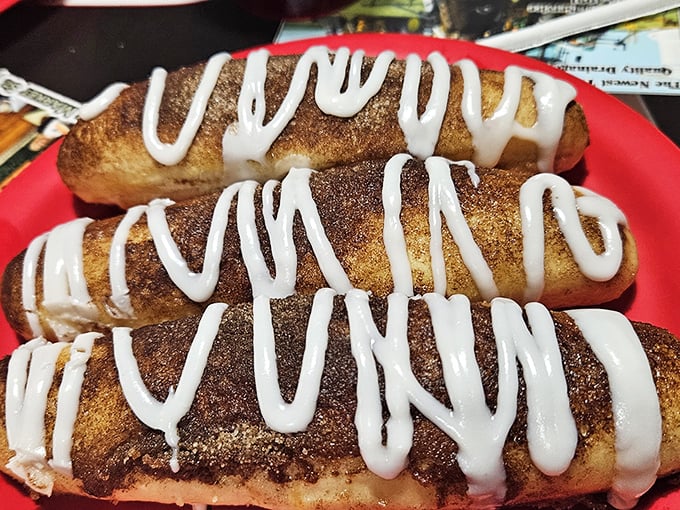 Cinnamon sticks drizzled with sweet icing – dessert disguised as breadsticks, proving that even pizza places understand the importance of a sweet finale.