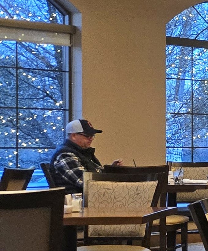 Winter blues stay outside while diners enjoy the cozy ambiance and arched windows framing a snowy Ohio afternoon.