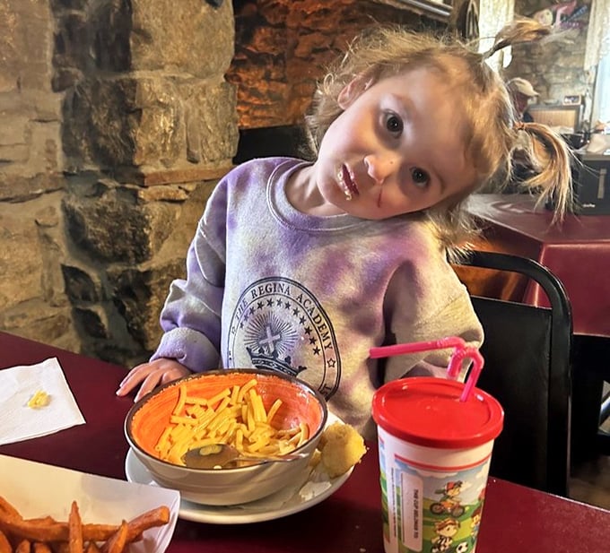 Family dining at its finest—mac and cheese that glows like edible sunshine. Some traditions are worth preserving, especially when they taste this good.