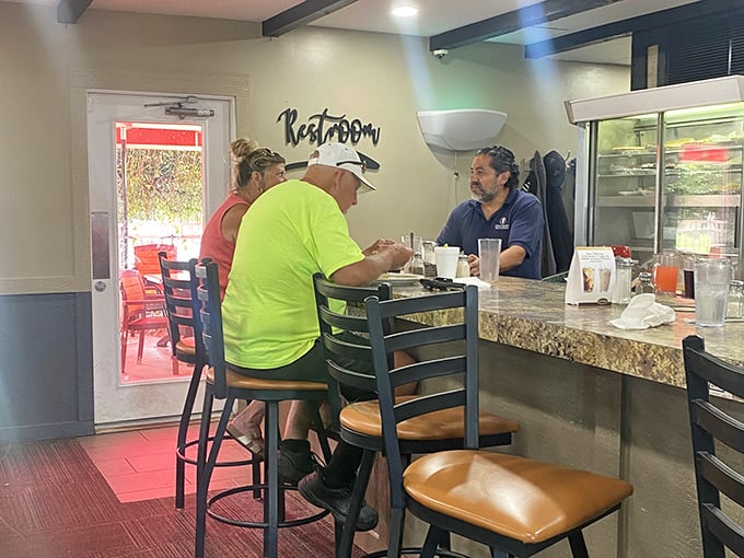 The counter seating – where solo diners become temporary neighbors and the green-shirted regular probably knows all the town's best stories.