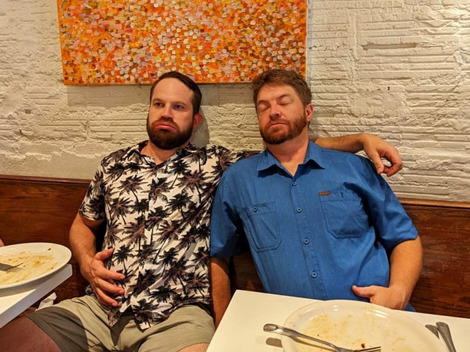 The universal food coma position—when Briarpatch's portions have defeated even the heartiest appetites and nap time becomes inevitable.