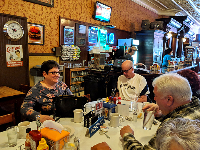 The breakfast counter—where locals exchange news, servers pour endless coffee, and strangers become friends over scrambled eggs.