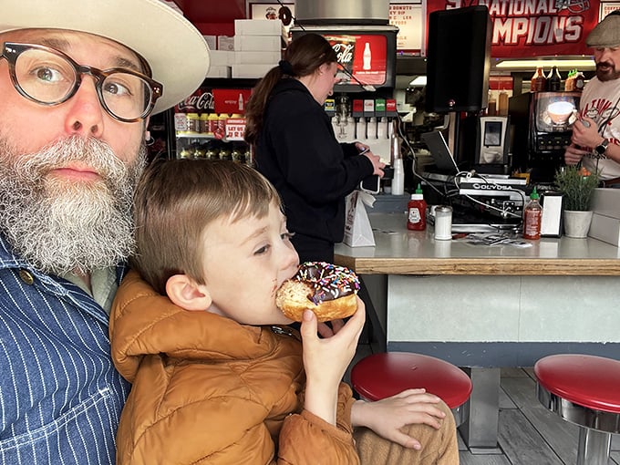 Passing donut wisdom down through generations—the proper sprinkle-to-bite ratio is serious business at Buckeye Donuts.