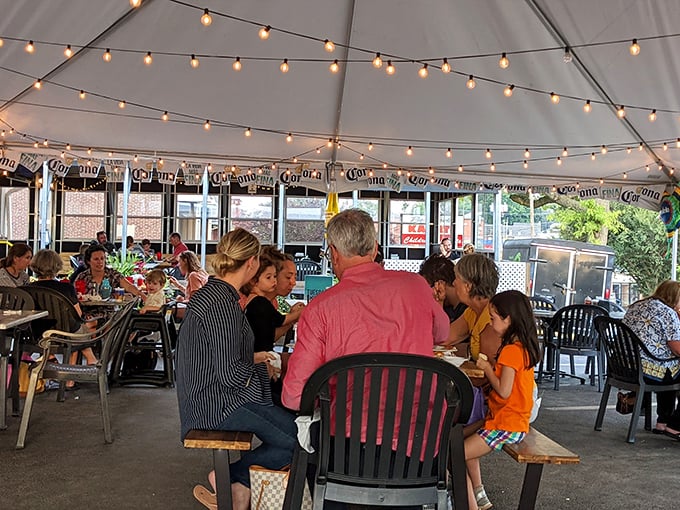 Under twinkling lights, strangers become neighbors and neighbors become family—the true magic of community dining.