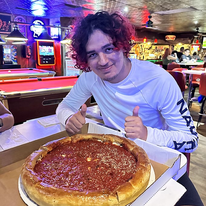The universal expression of pizza happiness knows no age limit. Two thumbs up indeed – this deep dish has clearly found its fan.
