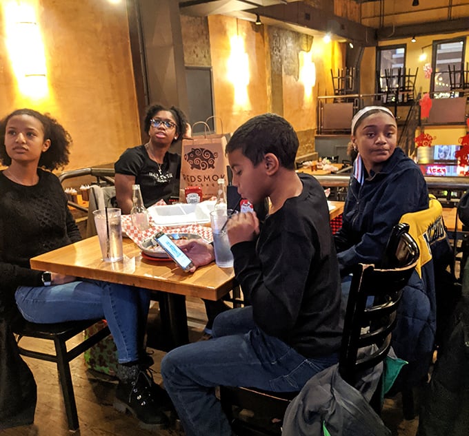 The universal language of barbecue brings people together—notice how nobody's talking because their mouths are happily occupied with smoked goodness.