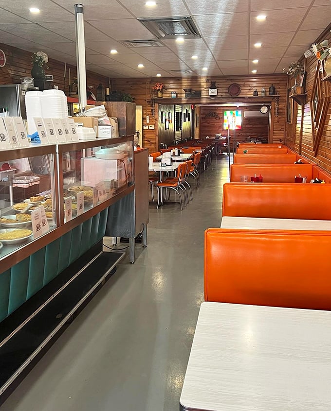 The diner's interior stretches back like a Norman Rockwell painting come to life, complete with display case temptations and cozy orange booths.