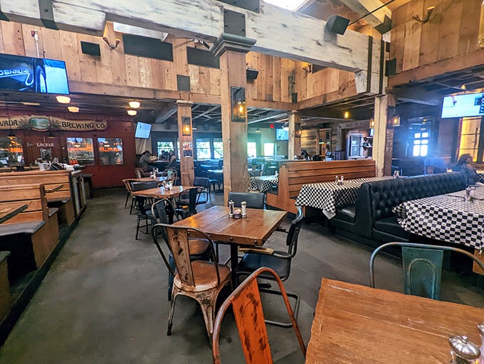 Wood beams and checkered tablecloths create rustic charm where families gather for serious barbecue business sessions.