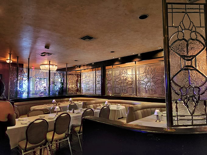 Old Hollywood meets modern comfort in this dining area where stained glass dividers create intimate spaces for serious eating business.