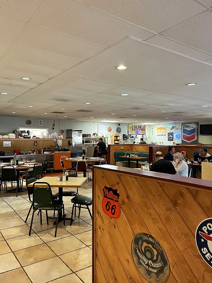 Vintage gas station signs and wooden dividers create an atmosphere where nostalgia isn't manufactured—it's earned through decades of consistent comfort.