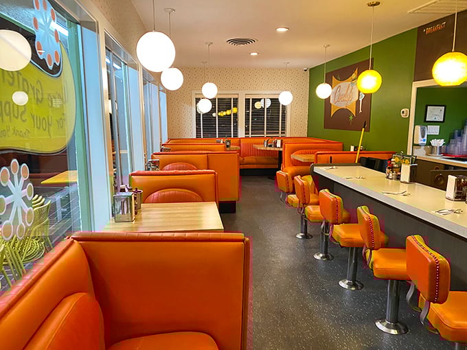 The diner's interior is a symphony in orange and green, where every booth tells a story and every counter seat promises satisfaction.