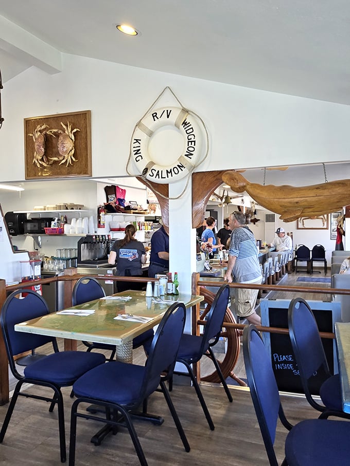 Beneath nautical treasures and a life preserver marked "King Salmon," diners gather at tables that have hosted countless coastal conversations and seafood celebrations.