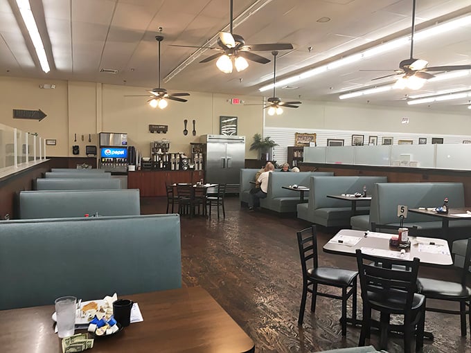 The dining room – where ceiling fans gently stir the aromas of home cooking and blue booths invite you to stay awhile.