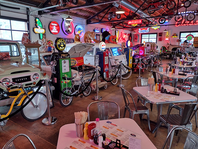 The dining area feels like the garage of your coolest uncle—if your uncle collected vintage bicycles, gas pumps, and neon signs.
