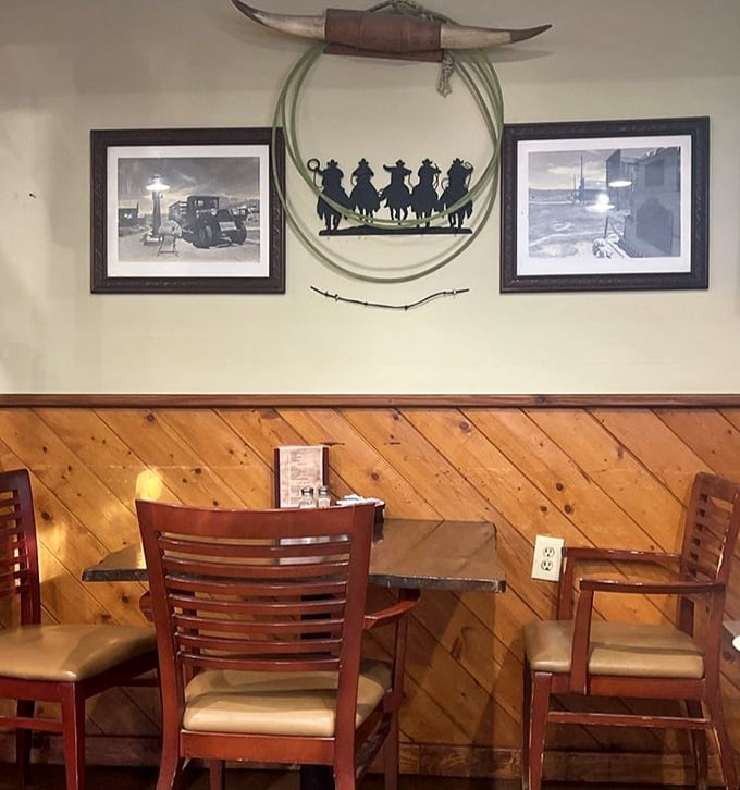 Western art and diagonal wood paneling create the perfect backdrop for meat-induced euphoria – like dining in a cowboy's dream living room.