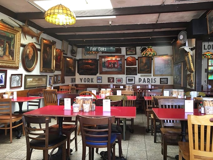 Every inch of wall space tells a story in this dining room. Street signs, vintage photos, and maritime art create an atmosphere of well-worn charm.