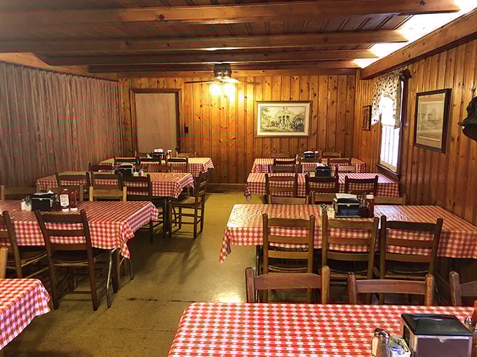 Red and white checkerboard tablecloths against pine paneling—the universal signal that serious, unpretentious eating is about to happen.