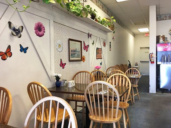 Butterfly decorations and hanging plants create that "your favorite aunt's kitchen" atmosphere where gossip flows as freely as the coffee.