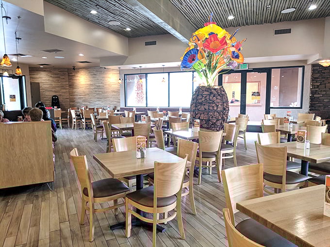 The dining room's colorful glass sculpture centerpiece steals attention from even the most photogenic meals. Light wood and clean lines create an atmosphere of casual elegance.
