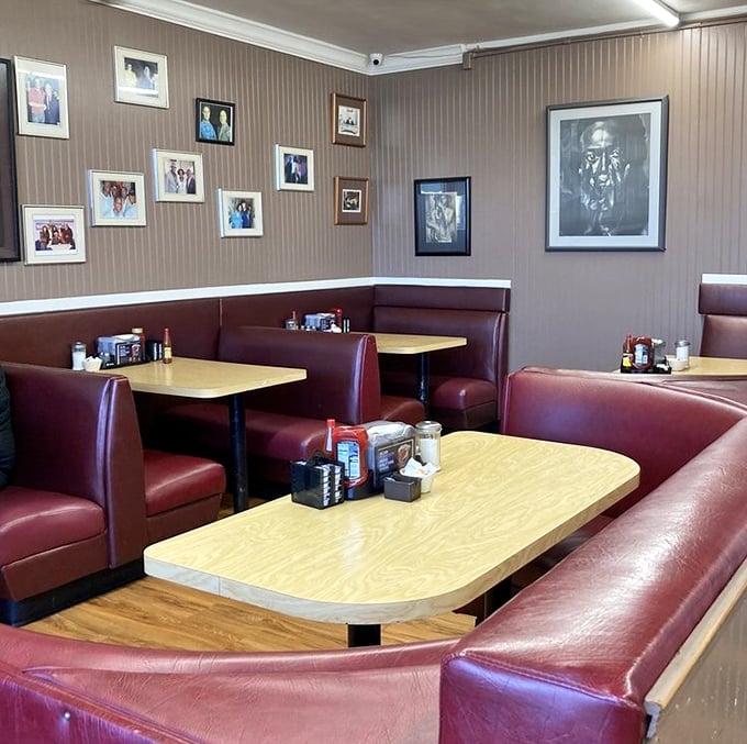 Red vinyl booths that have cradled more meaningful conversations than most therapists' offices. The photos on the wall aren't decoration—they're family.