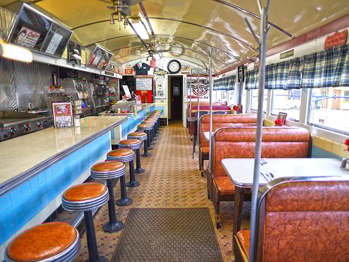 The railway car interior creates the perfect dining capsule where time slows down and conversations actually happen.