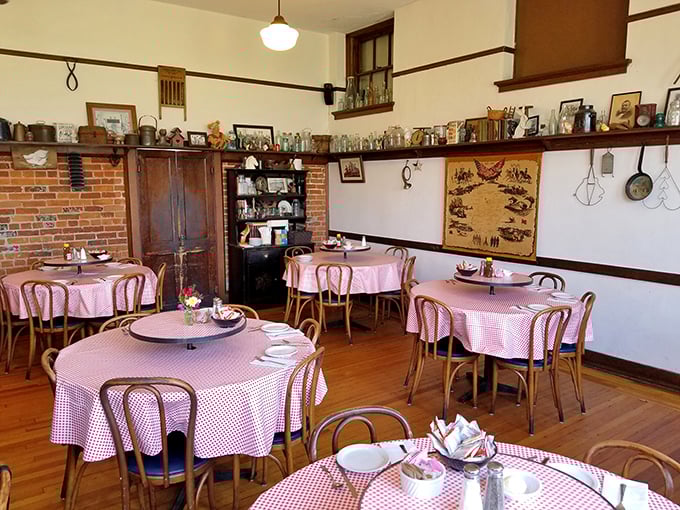 Pink checkered tablecloths and antique treasures create a dining room where every meal feels like Sunday dinner at your favorite relative's house.