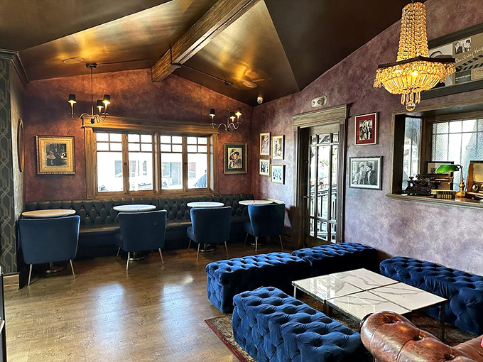 The lounge area's blue velvet seating and crystal chandelier create the living room you wish you had – minus the remote control arguments.