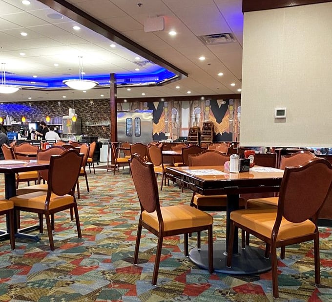 Empty tables waiting for their next story—where first dates, family celebrations, and Sunday morning recoveries all unfold under the same blue glow.