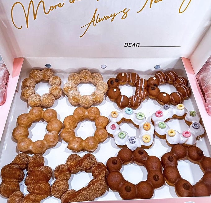 A dozen donuts arranged like edible flowers—some cinnamon-dusted, some chocolate-dipped, all begging to be the first chosen.