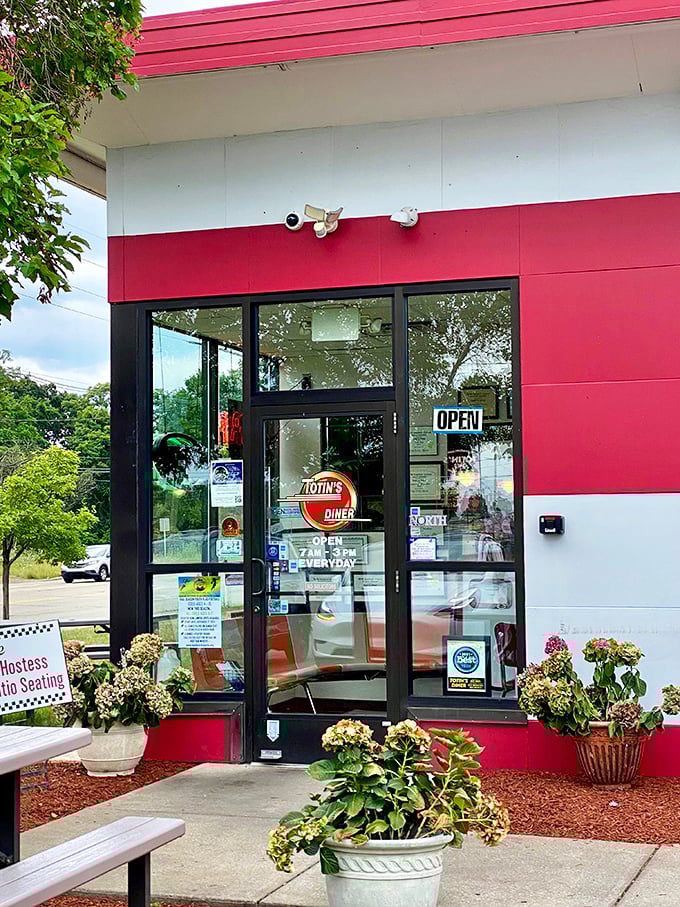 The entrance promises what awaits inside—classic diner fare in a setting that respects tradition. That "OPEN" sign never looked so inviting.