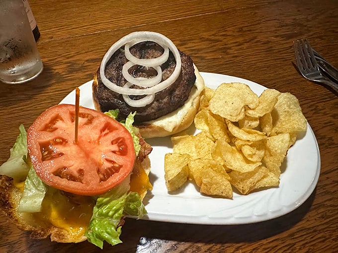 Not just a burger—a masterclass in proper beef-to-bun architecture. Those crispy chips on the side are just showing off at this point.