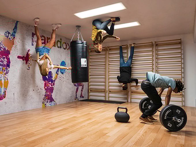 Defying gravity is just another day at the Paradox Museum, where visitors appear to hang from the ceiling in this cleverly designed gym illusion.