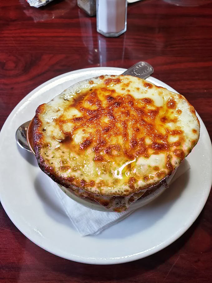 French onion soup that's more cheese than bowl—a bubbling cauldron of comfort that requires a commitment and possibly a nap afterward.