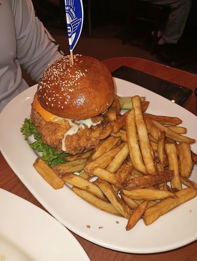 This isn't just a chicken sandwich—it's a masterclass in texture. That golden-brown exterior practically sings when you cut into it. Fries looking mighty fine too.