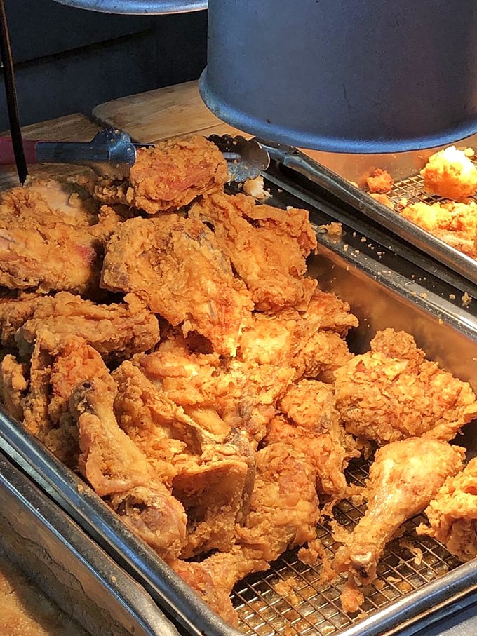 Golden-fried chicken waiting for its close-up, each piece promising that perfect crunch followed by juicy tenderness that keeps locals coming back for decades.