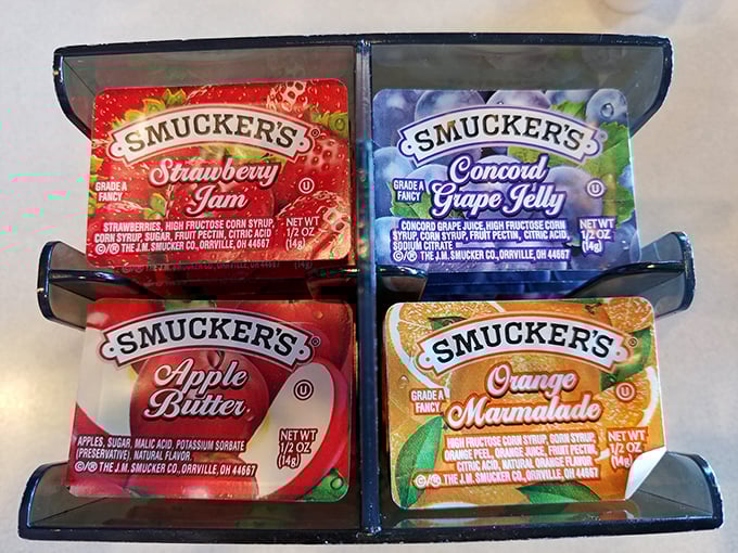 The jam caddy—where Smucker's varieties wait patiently to transform ordinary toast into the highlight of your breakfast battlefield tour.