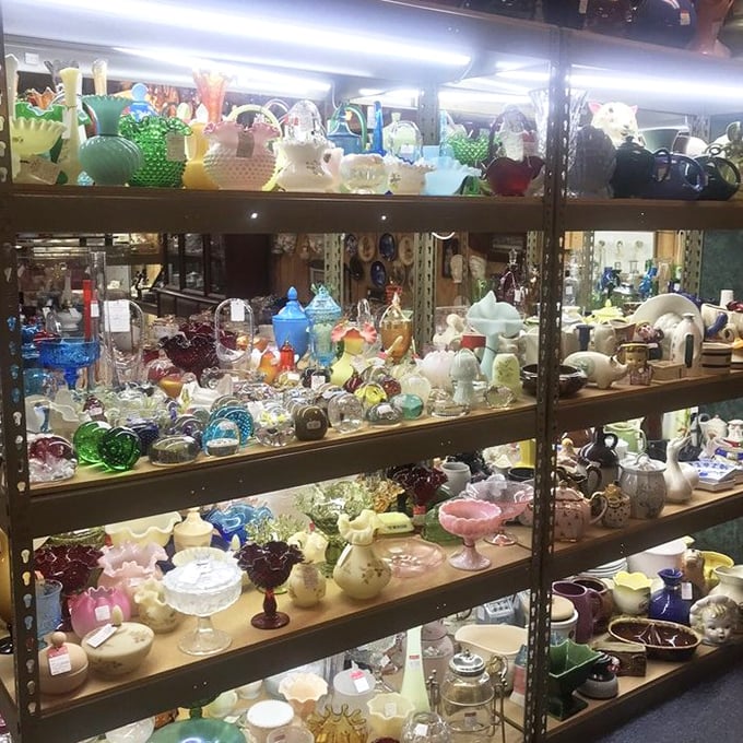 A rainbow captured in glass—Depression-era treasures catch the light, transforming ordinary shelves into an extraordinary kaleidoscope of color.