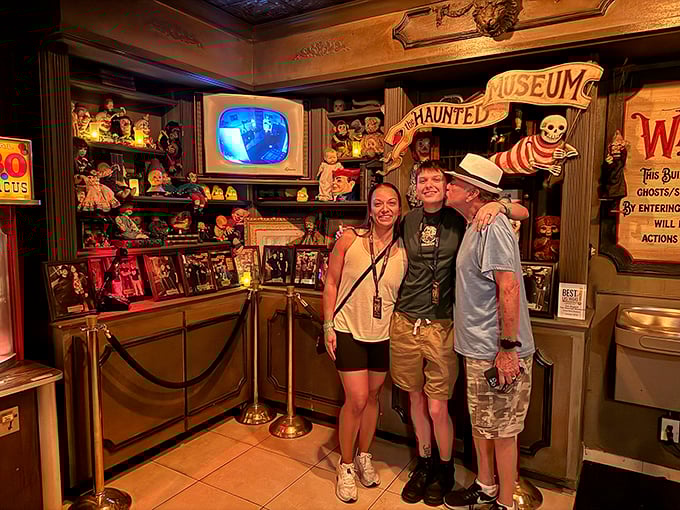 Visitors pose for a souvenir photo, their smiles saying "fun museum" while their eyes scream "please let me make it to the exit." 