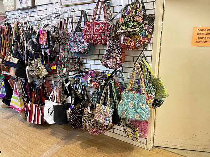 The handbag wall—a kaleidoscope of patterns and colors where Vera Bradley meets vintage finds in a fashionable conversation.